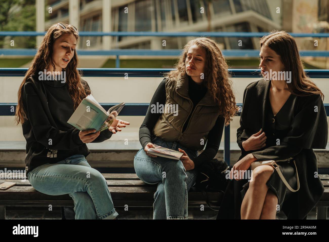 Long haired brunette girl telling a sad story from the book she read ...