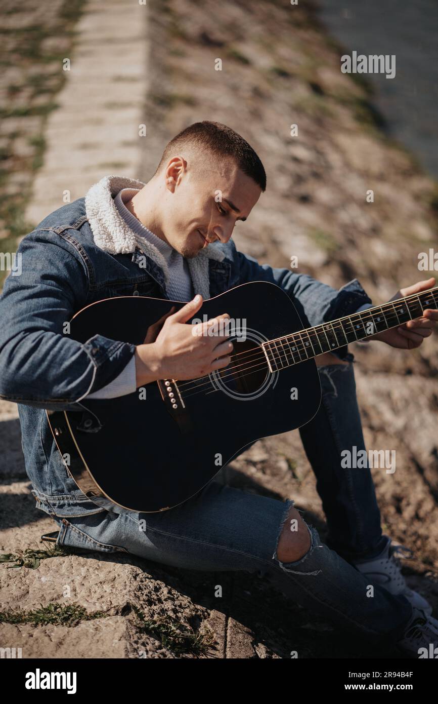 Man playing guitar on stairs hi-res stock photography and images - Alamy