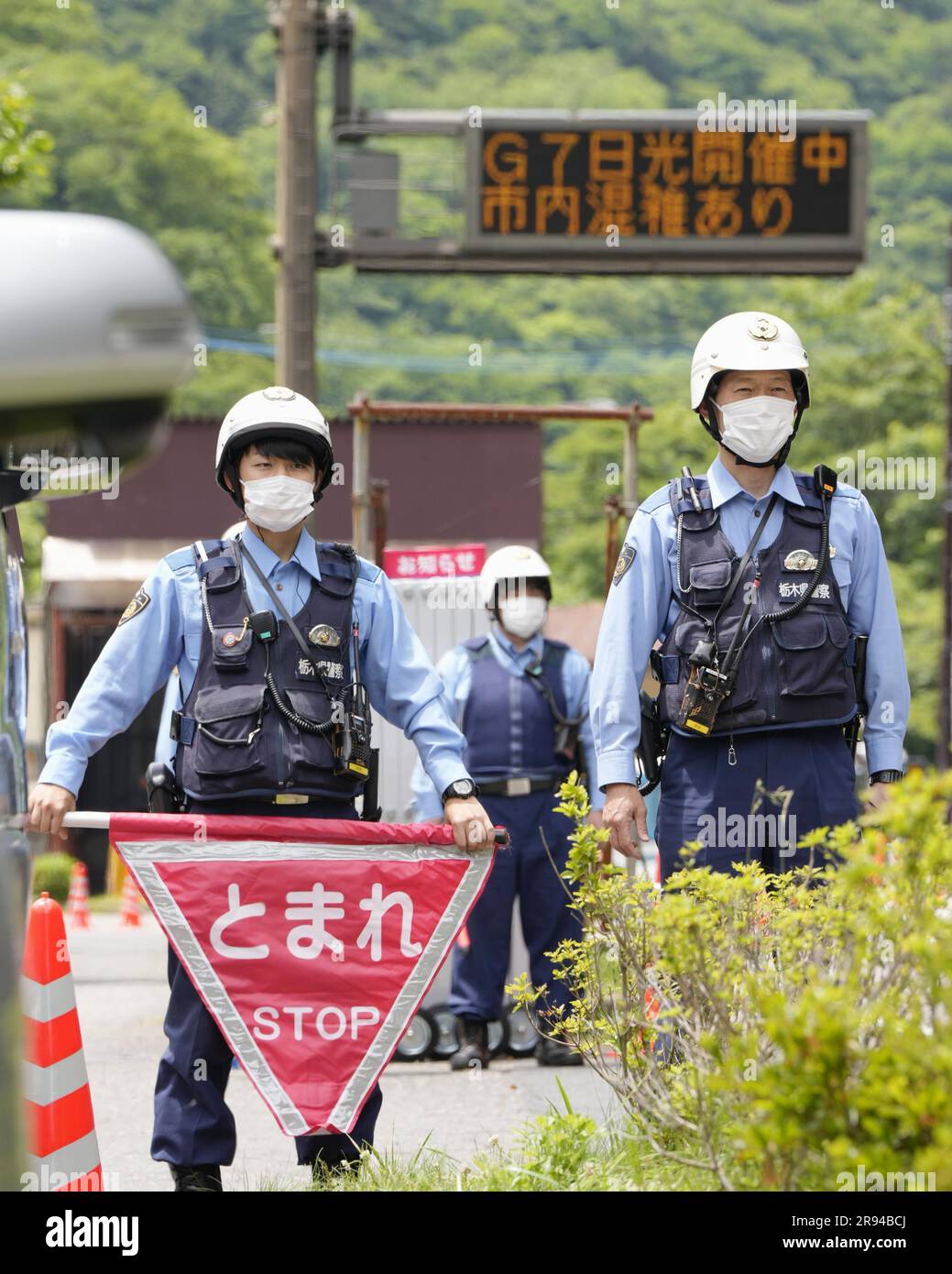Police officers stand at a checkpoint set up near the venue of a ...