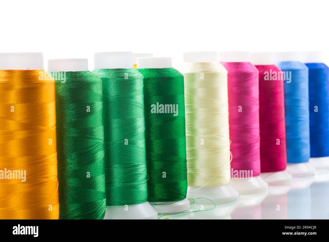 set of different color sewing threads, isolated on white background ...