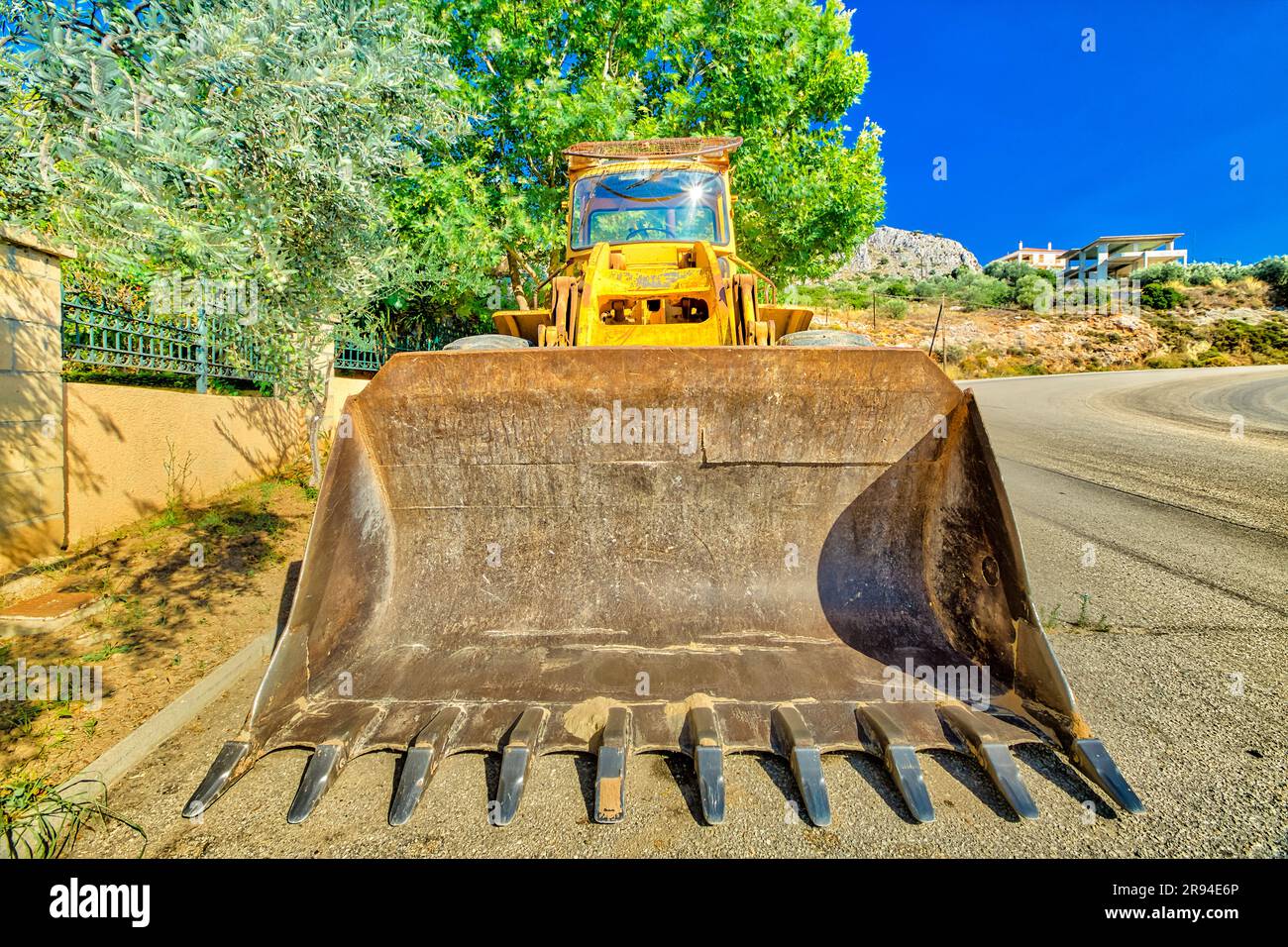 Front view of yellow bulldozer excavator on wheels for building work on ...