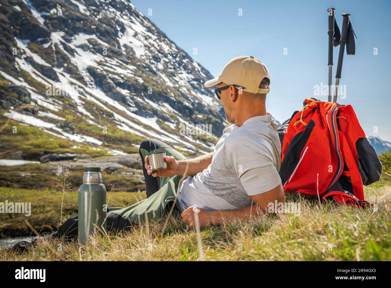 Hiker Taking Short Coffee Break on a Scenic Trail. Laying on the Early ...