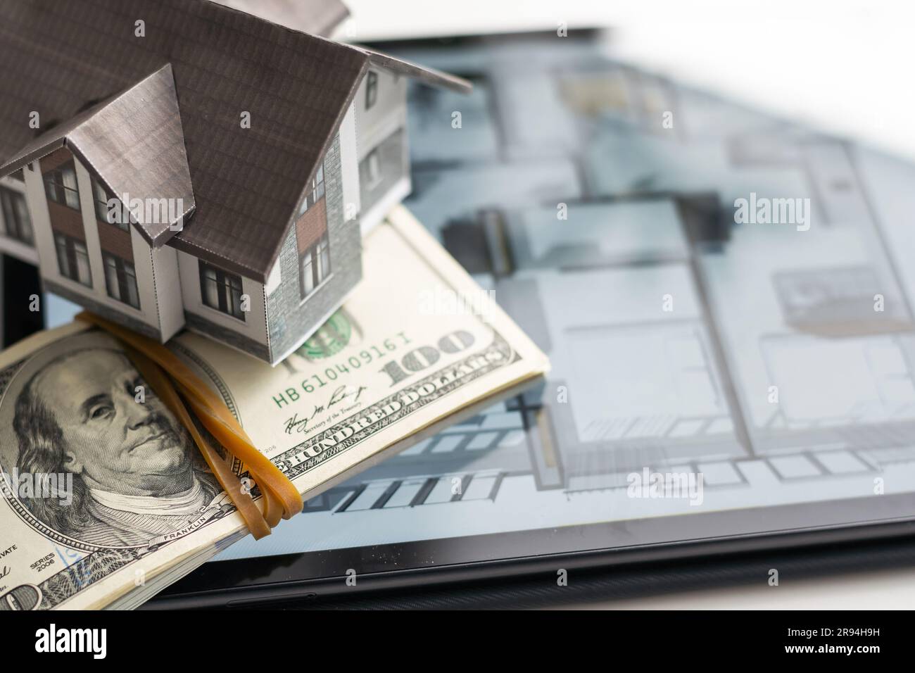 Small house model is on screen tablet and icons home electronics ...