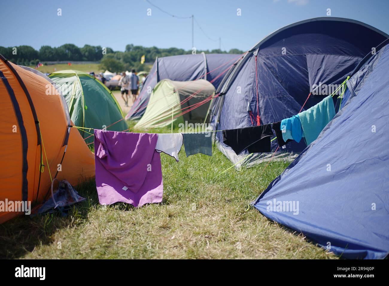 Towels drying on a washing line between tents, during the hot weather ...