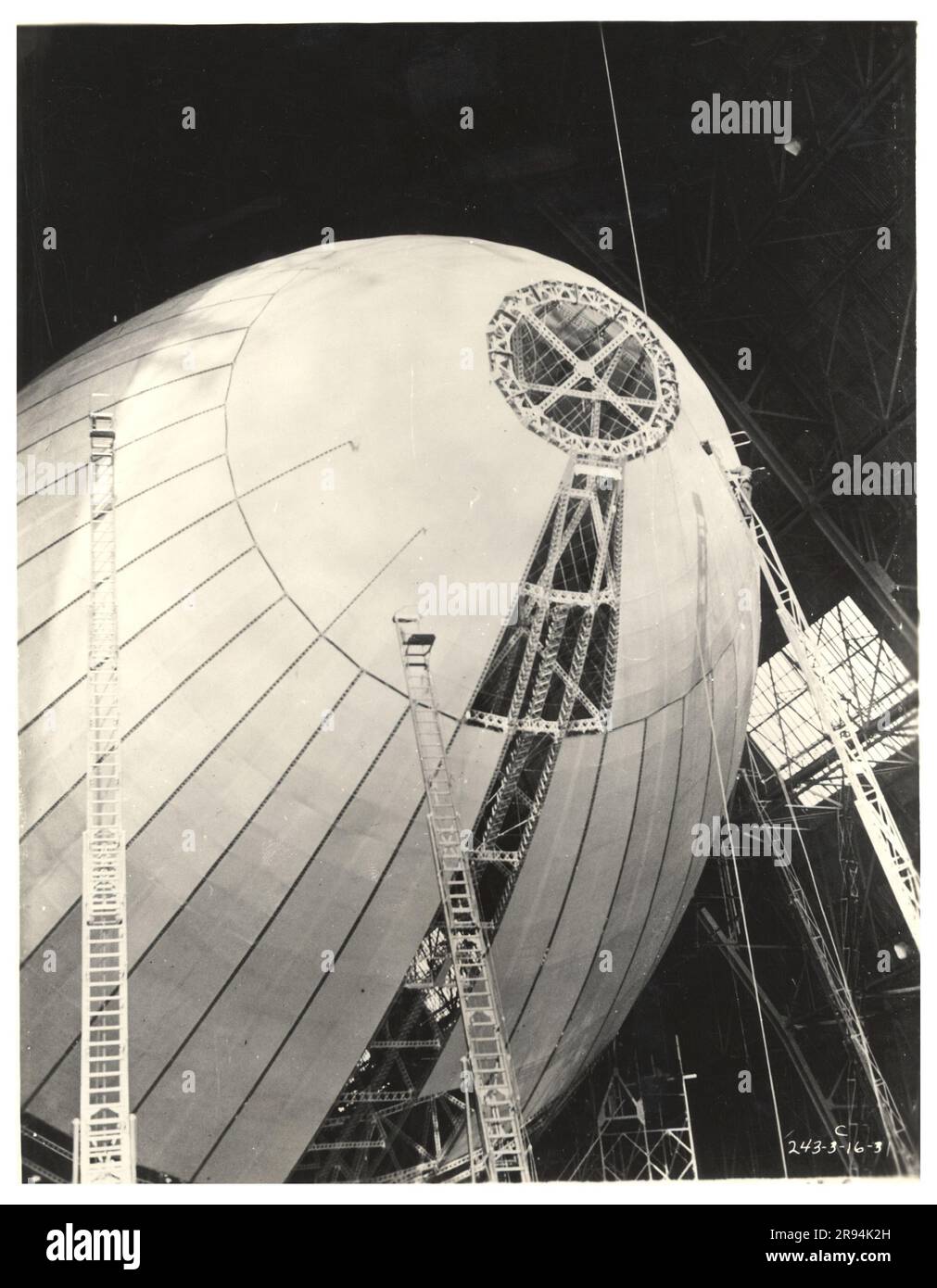 Photograph of the Outer Cover being Applied to the Nose Section of a Dirigible. Original caption ...