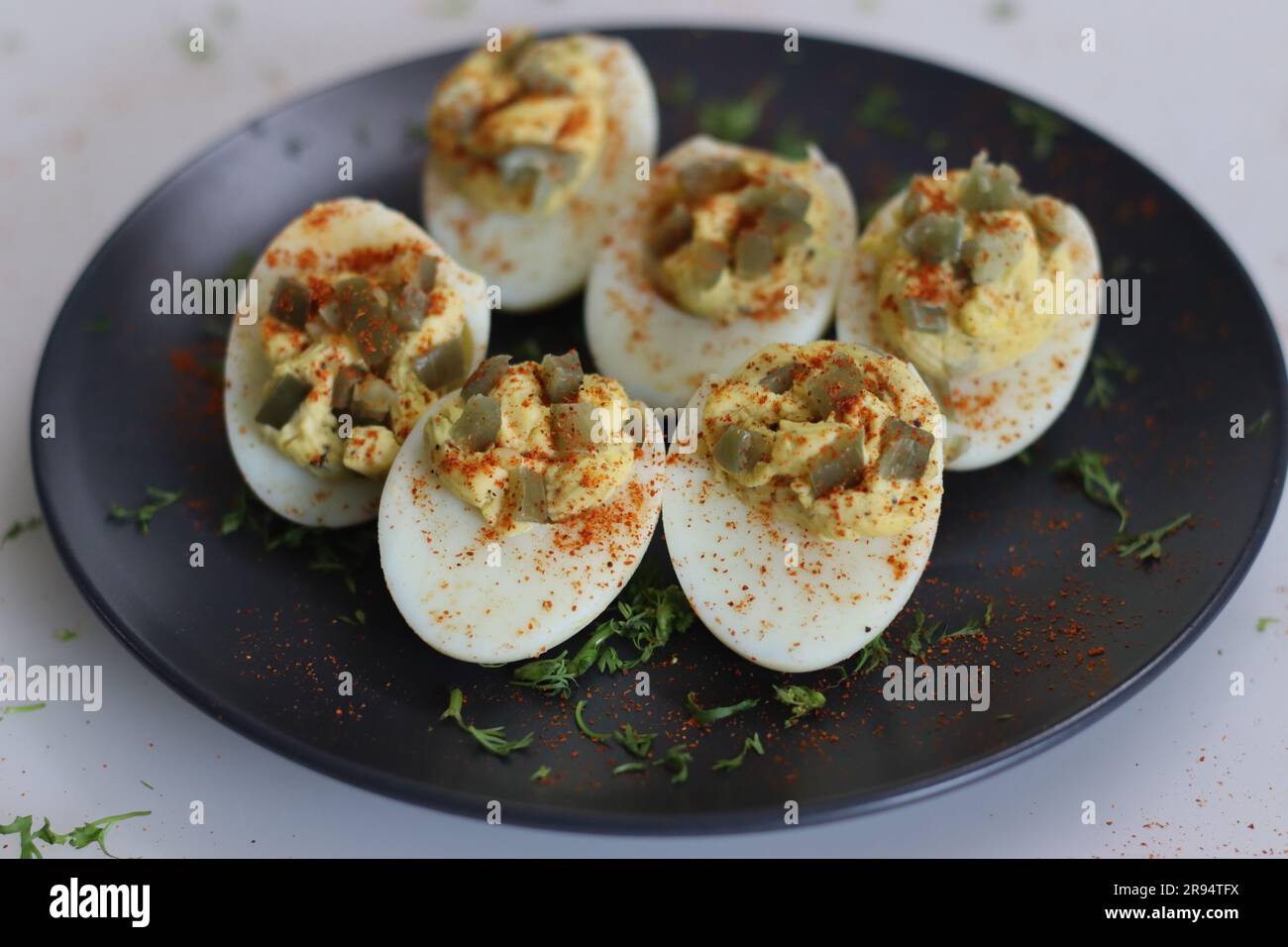 Stuffed eggs. Hard boiled eggs cut into half and stuffed with a paste ...