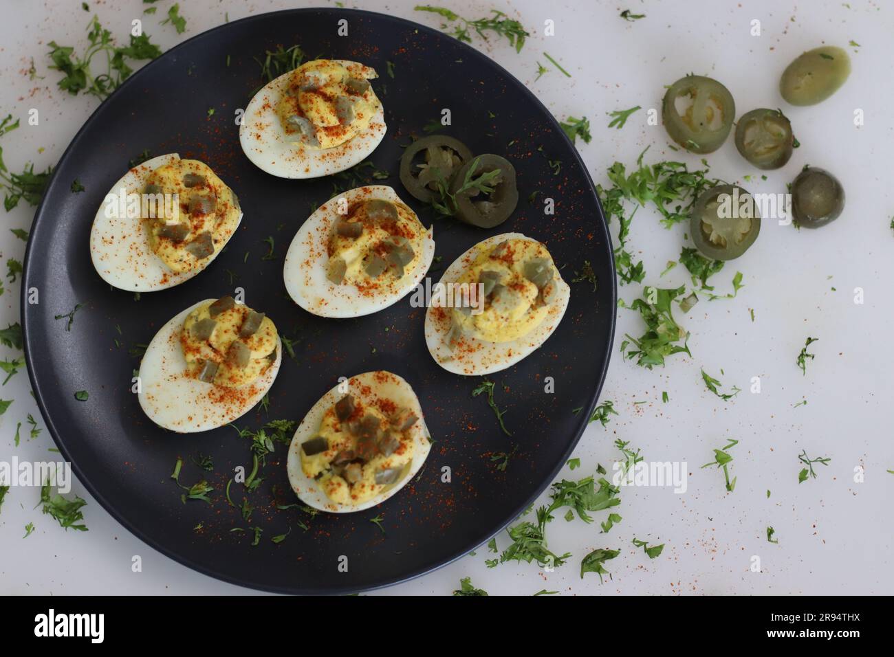 Stuffed eggs. Hard boiled eggs cut into half and stuffed with a paste ...