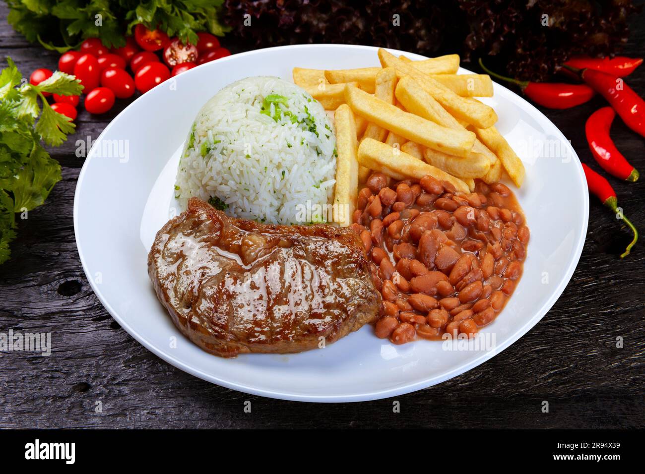 Rice, beans, french fries and meat Stock Photo - Alamy