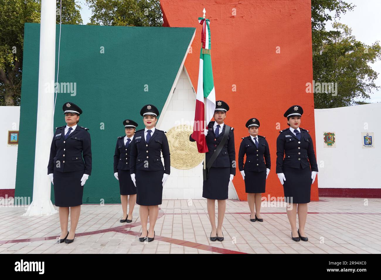 The female police officers stand in a row in front of the flag of ...