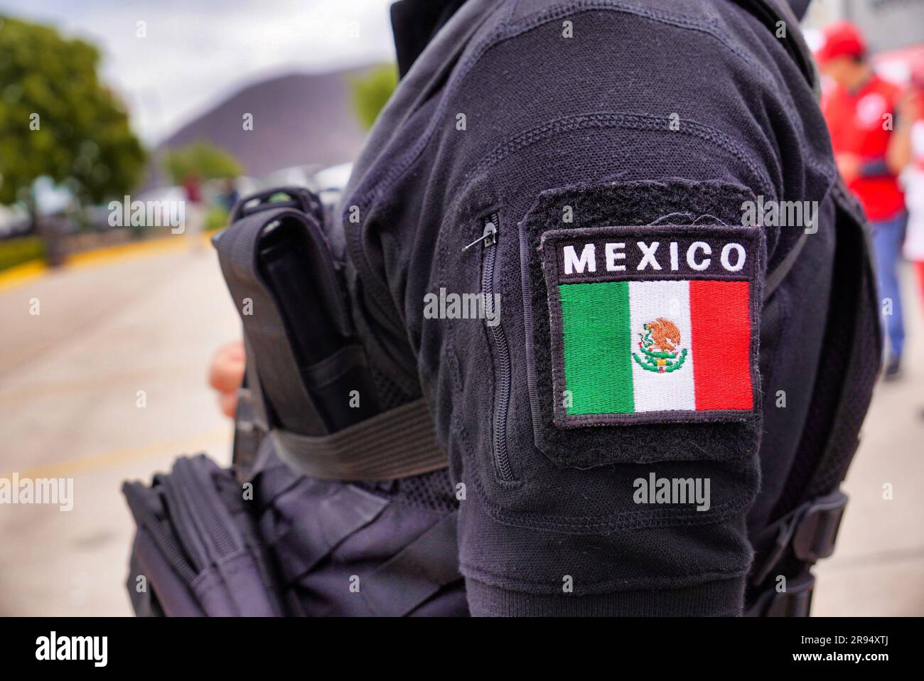 A closeup of the flag of Mexico on the arm of an uniformed Mexican ...