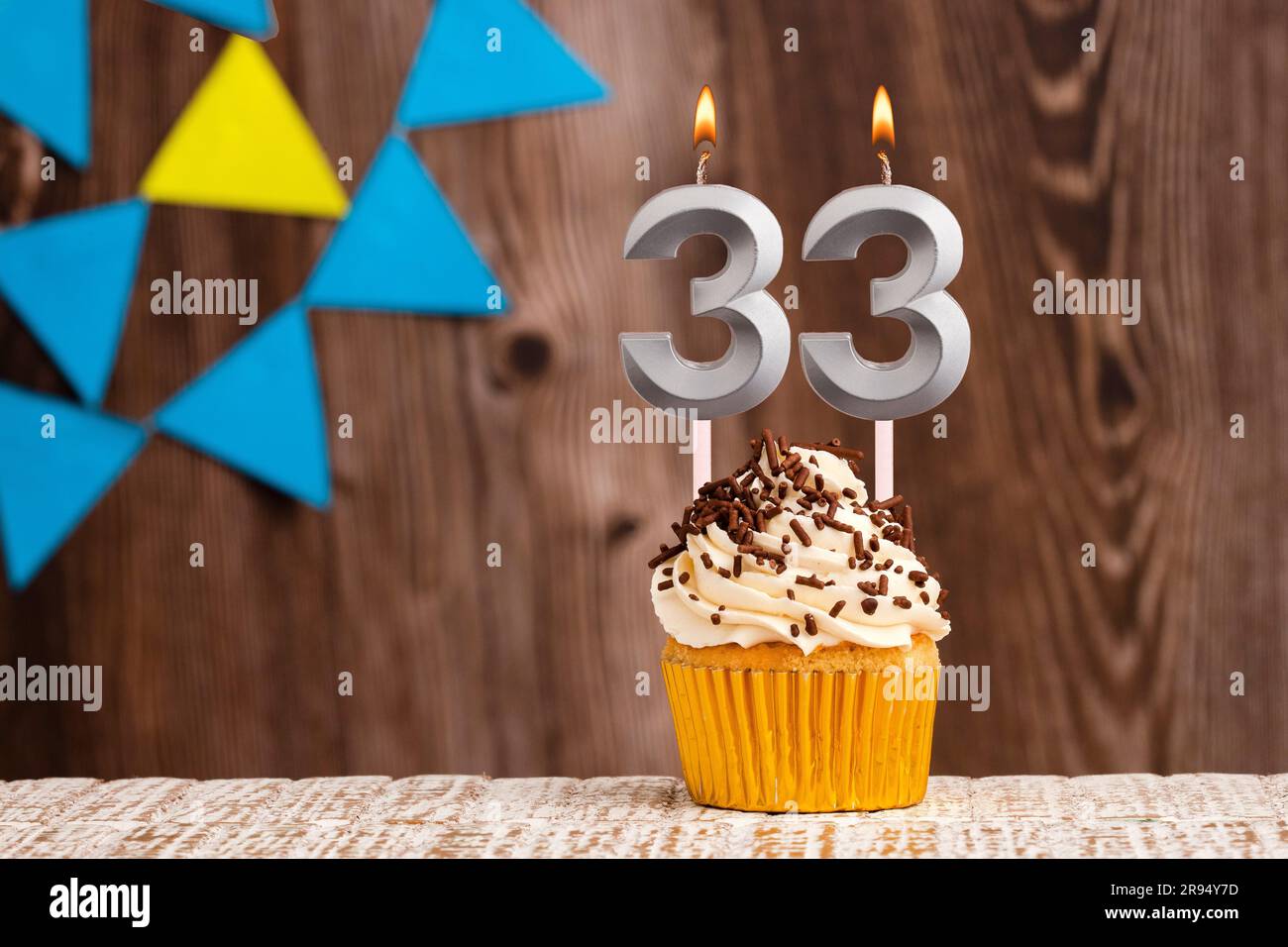 Birthday card with candle number 33 - Wooden background with pennants ...