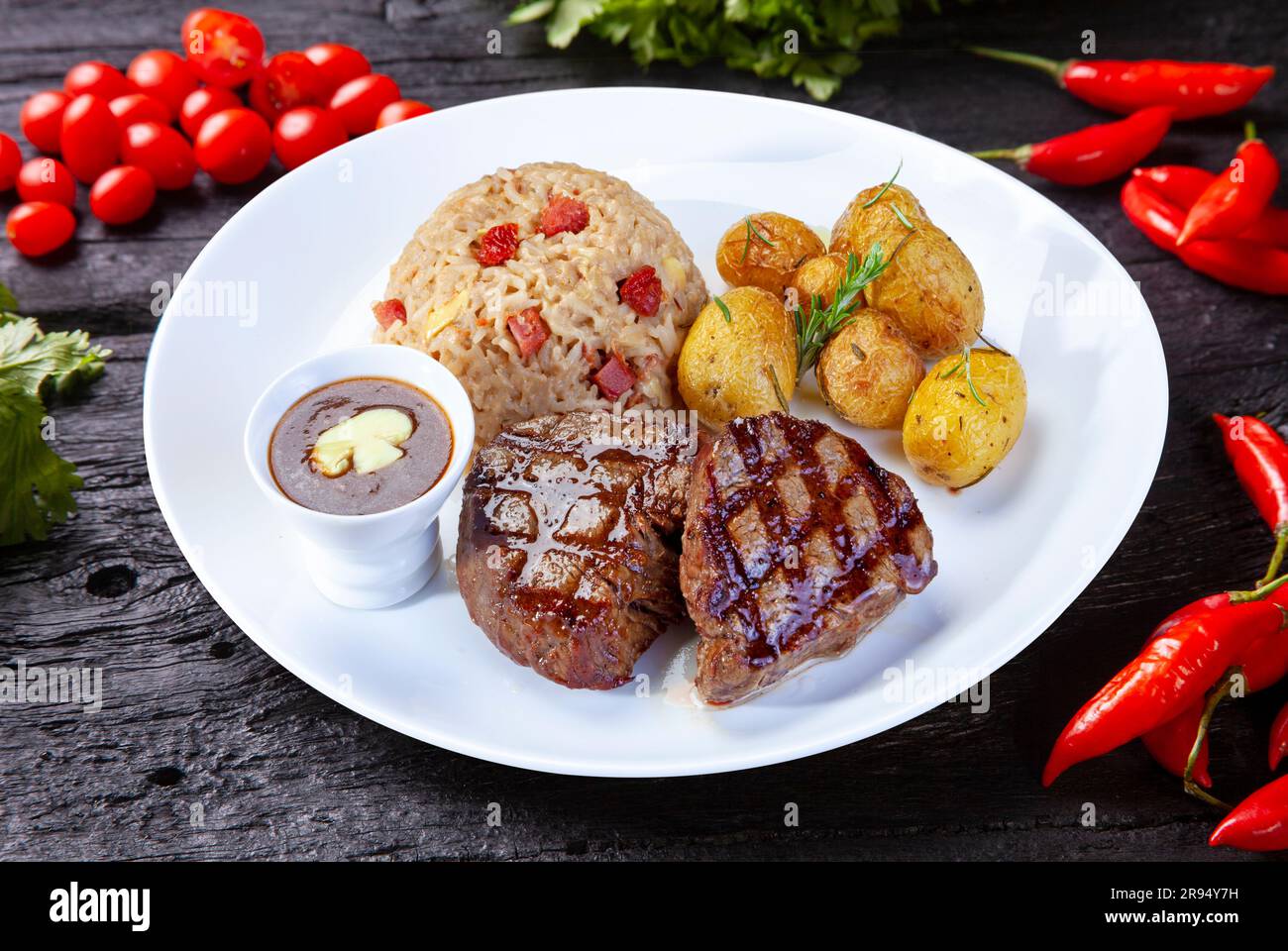 Roasted steak meat, potatoes and rice Stock Photo - Alamy