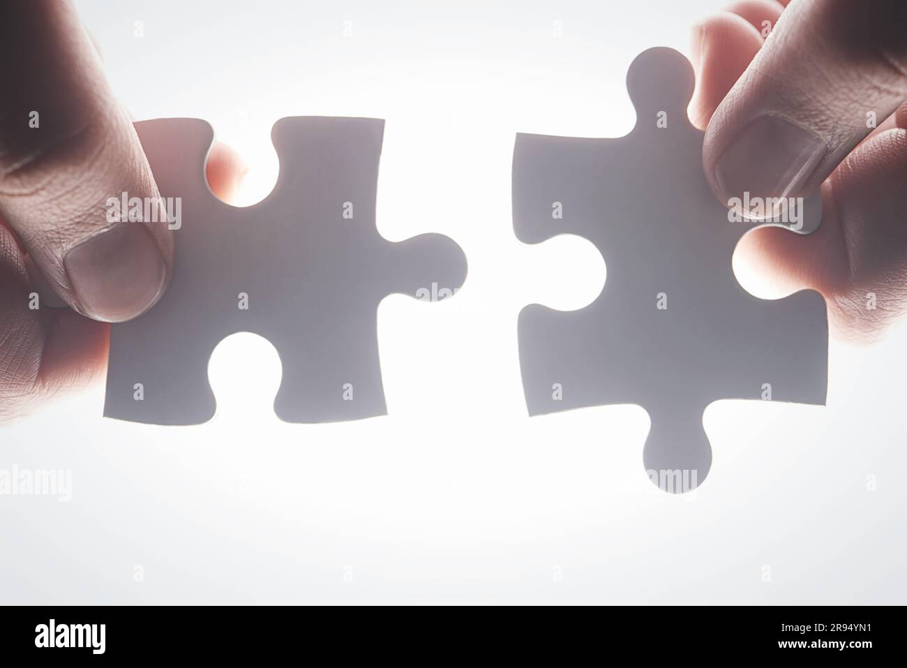 Puzzle, teamwork and synergy with hands of person on white background ...