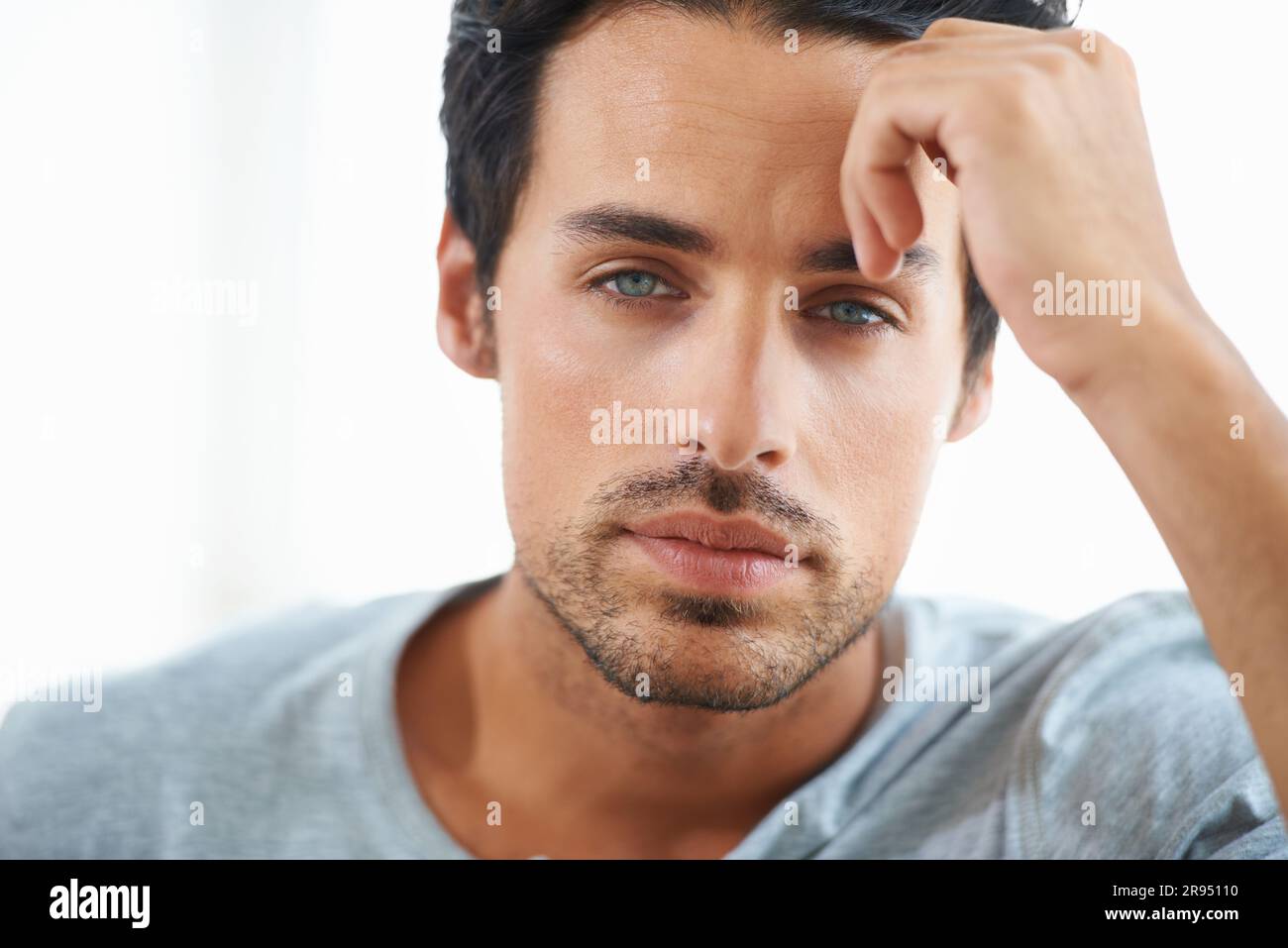 Serious man, closeup and face of handsome model or resting hand on head ...
