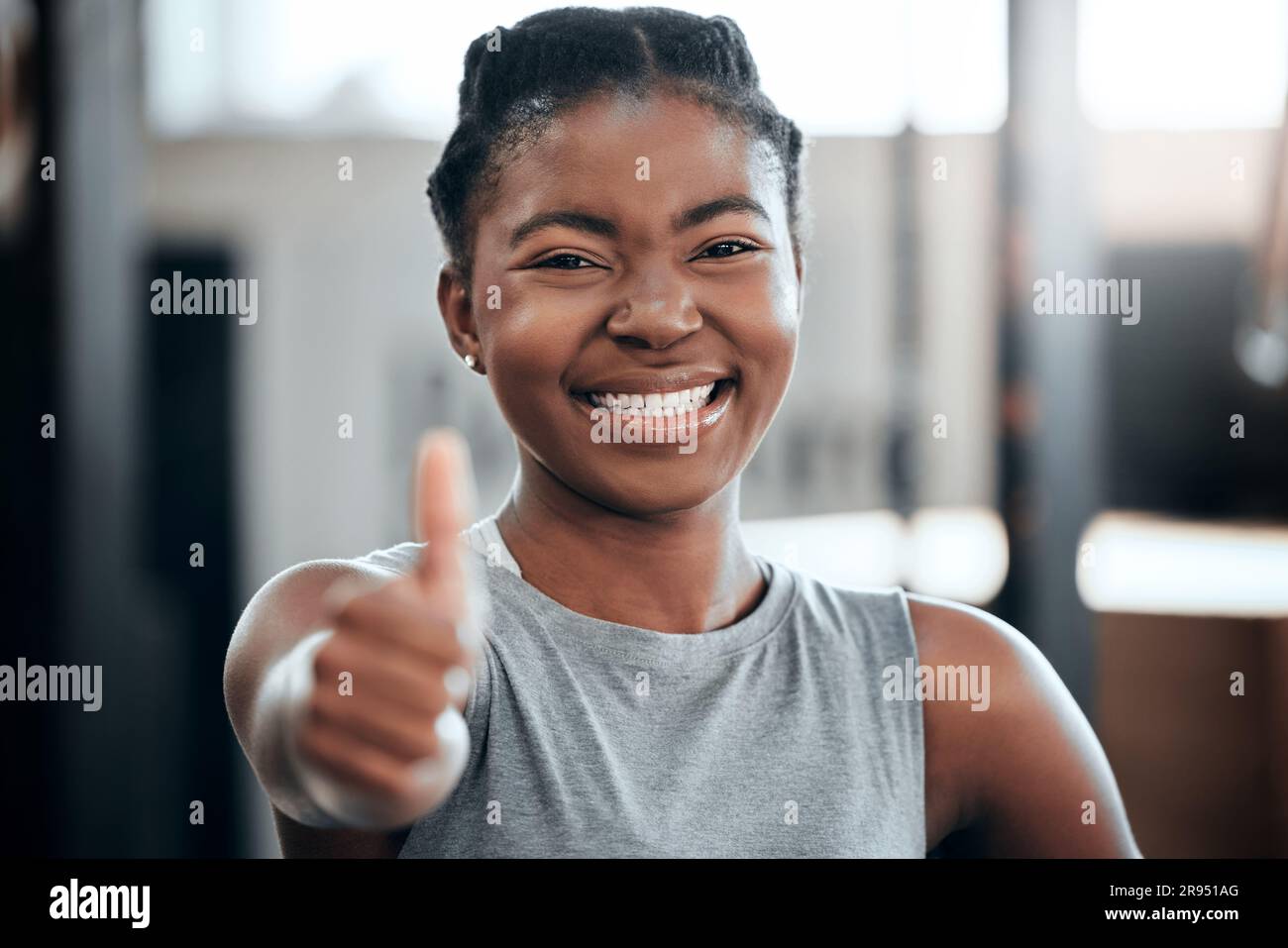 Fitness, portrait or happy black woman with thumbs up in gym training ...