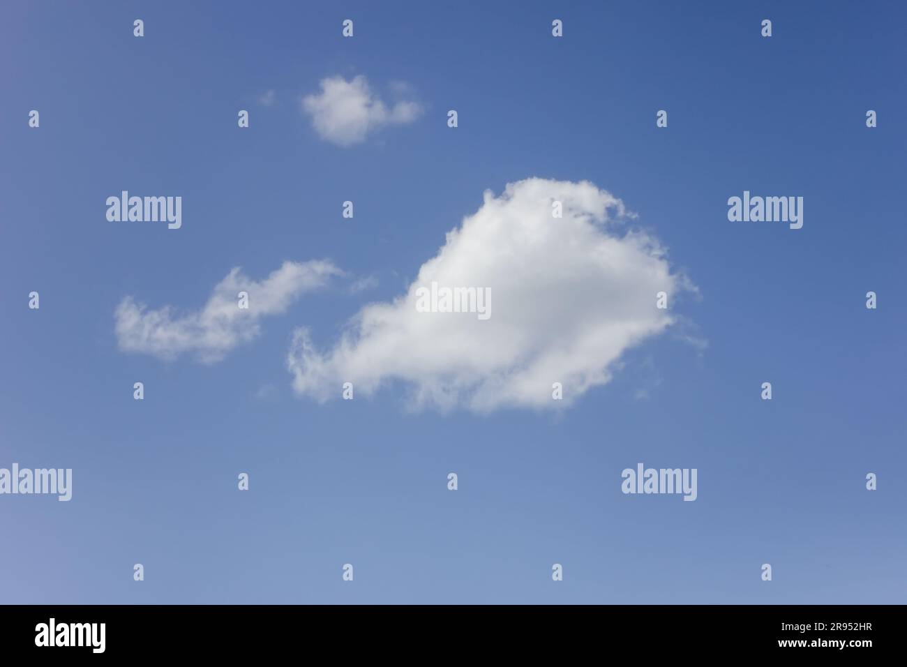Single cloud over the blue sky. Clouds floating in the clear blue sky ...