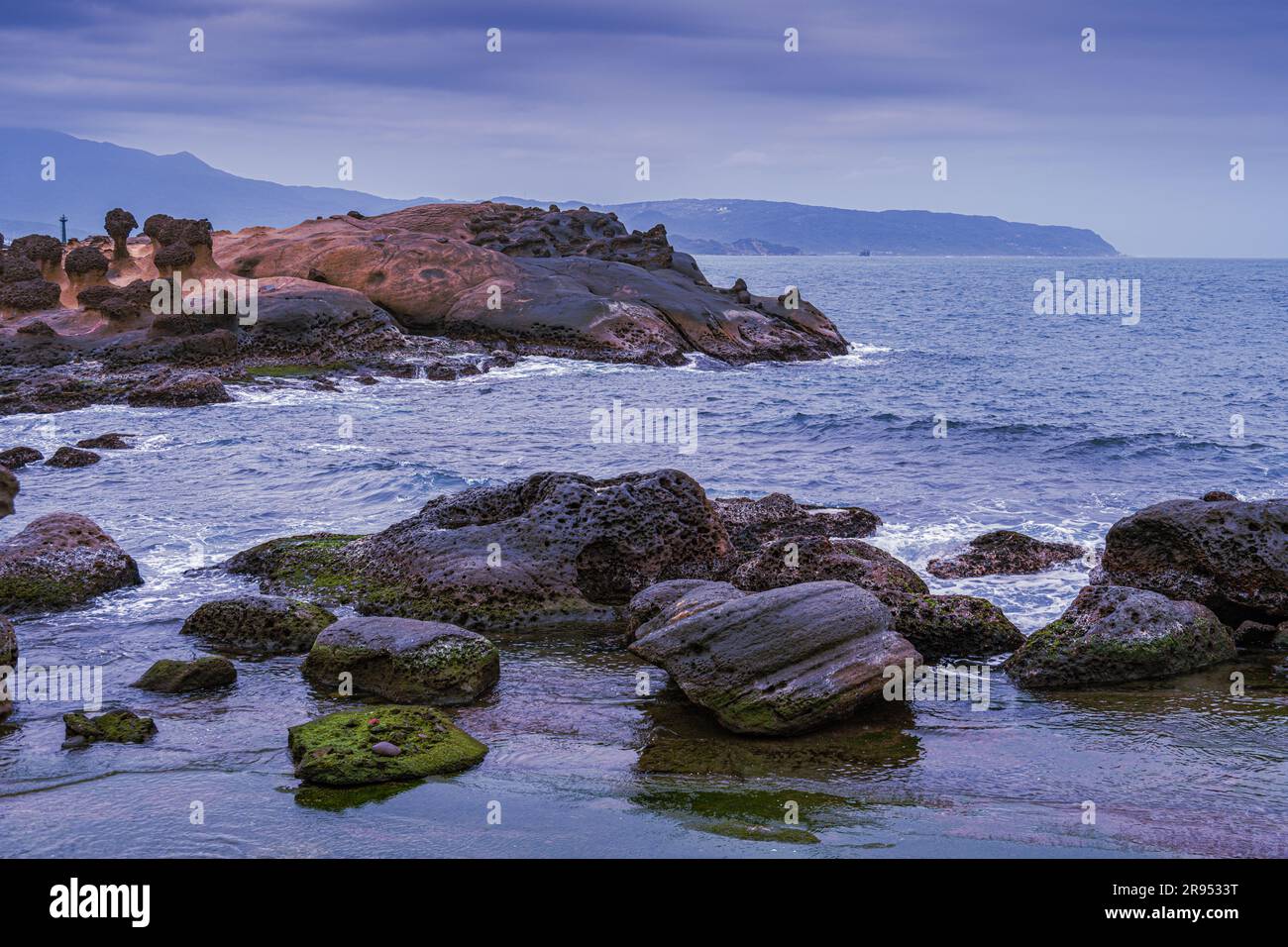 A blue tinged photo looking out over the sea from Yehliu Geopark in ...