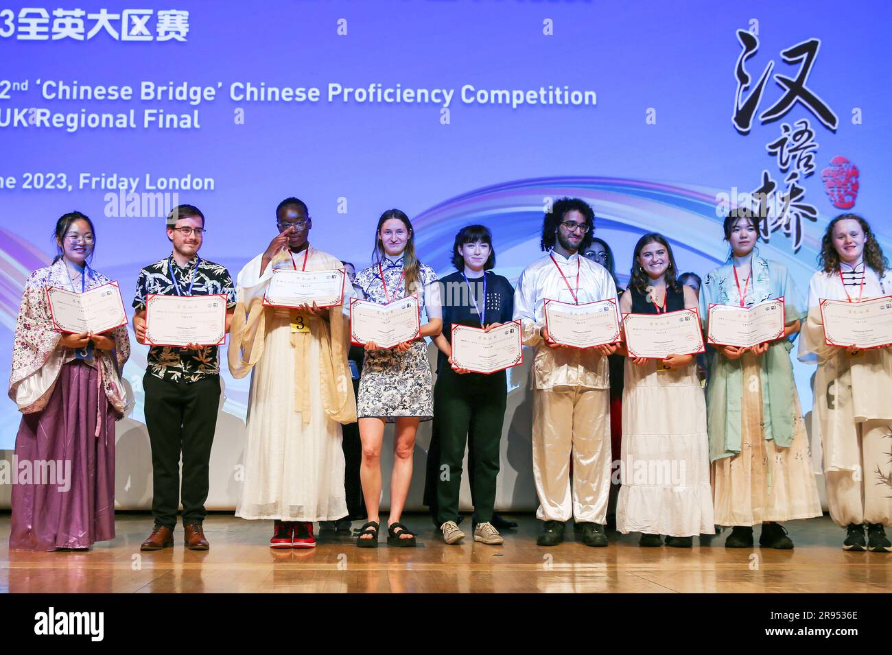 London, UK. 24th June, 2023. Students pose with their certificates ...