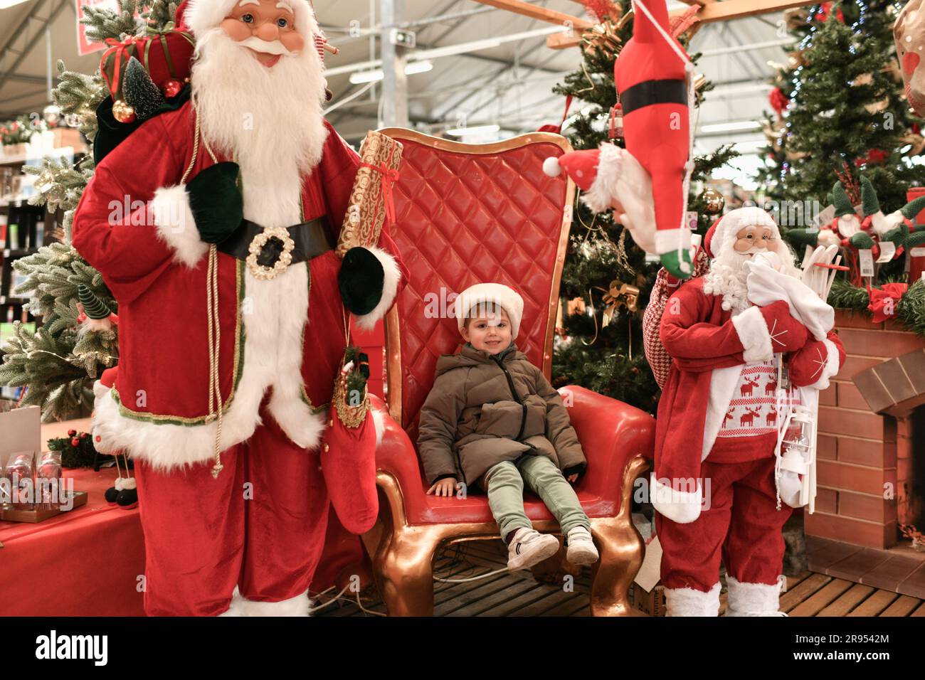 A boy in a hat visiting Santa Claus Stock Photo - Alamy