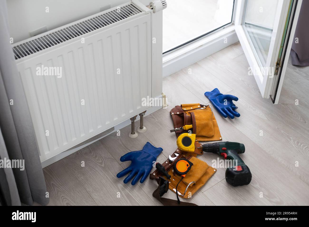 White hot water heater radiator built inside drywall indoors at home ...