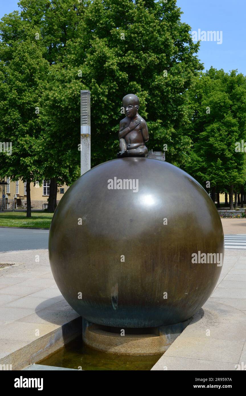 A figure seated on a sphere. Bad Pyrmont, Germany Stock Photo - Alamy
