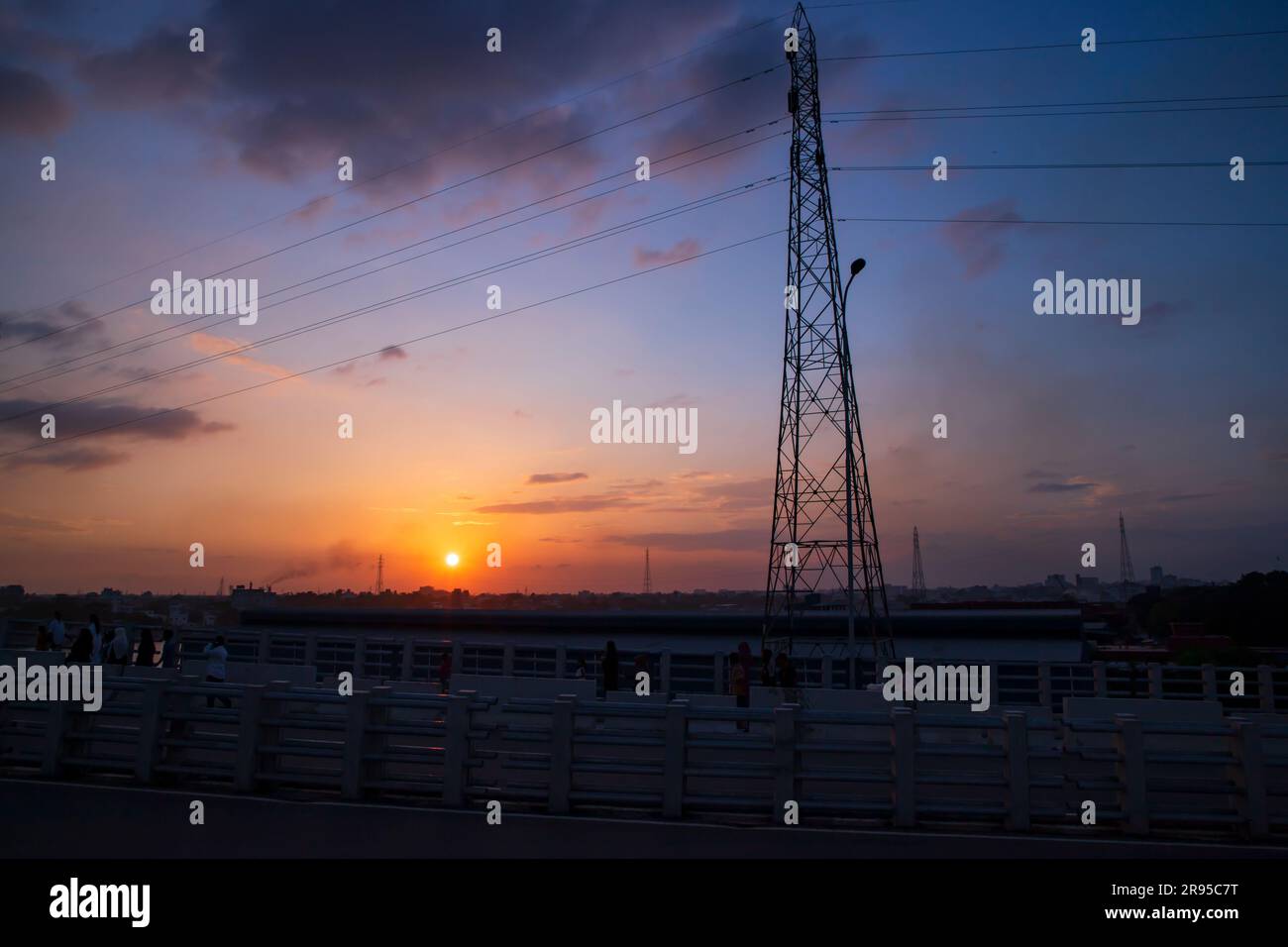 Silhouette of the high voltage power line at sunset in Narayanganj ...