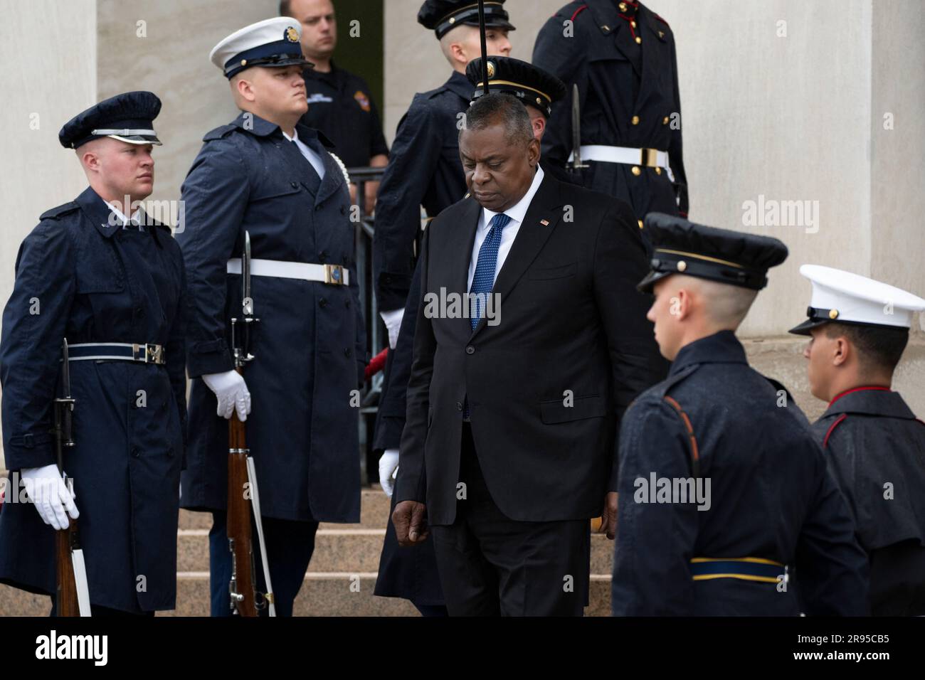 Secretary of Defense Lloyd Austin walks down the steps of the Pentagon ...