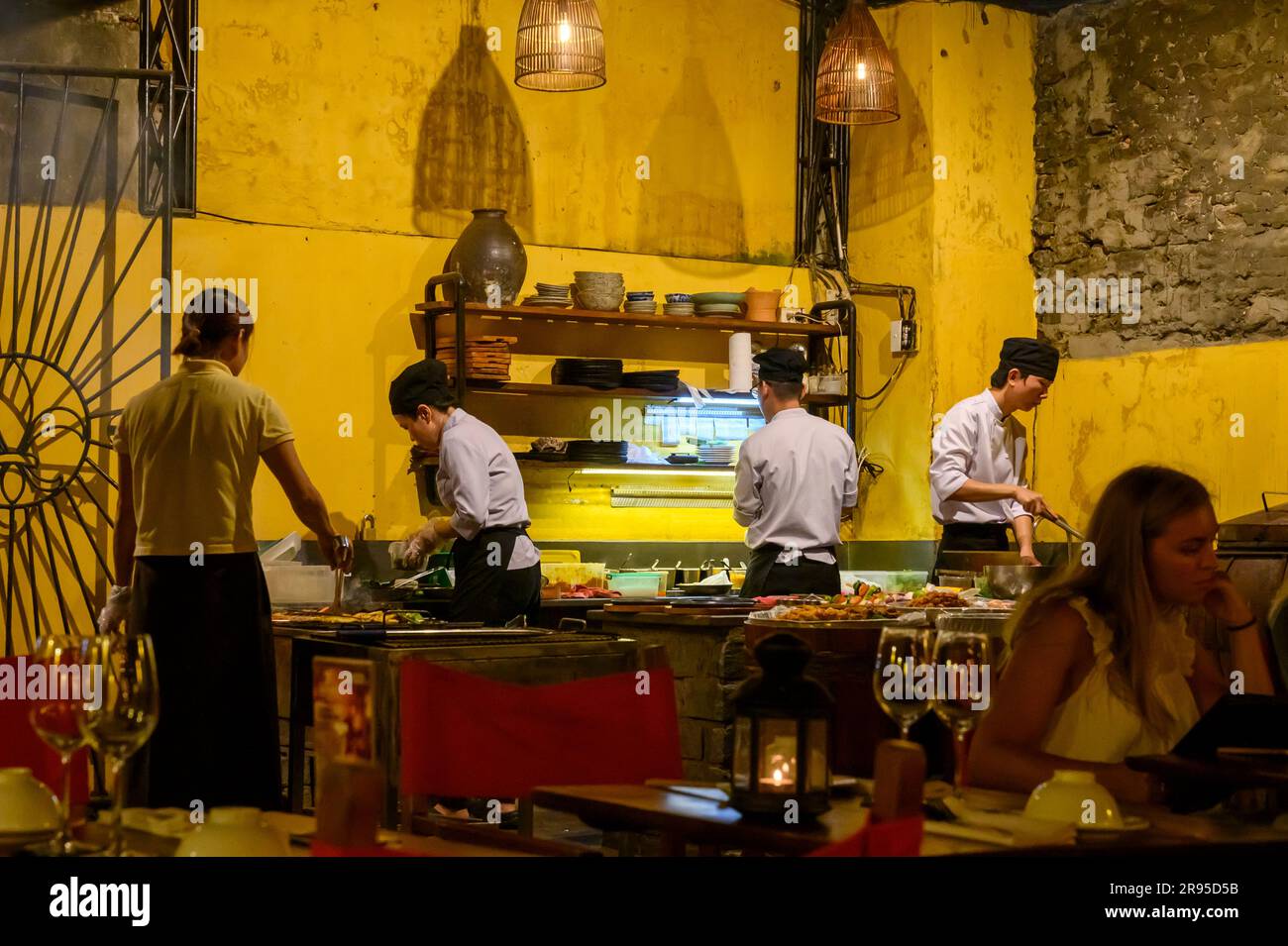 Chefs cooking food in Hai Café Courtyard BBQ & Restaurant in the old ...