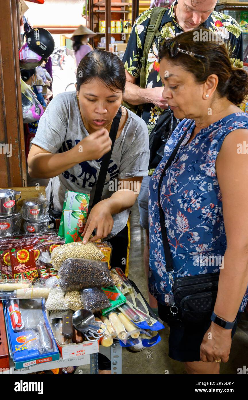 A spice vendor explains different types of peppercorns to a tourist in ... A spice vendor explains different types of peppercorns to a tourist in ...
