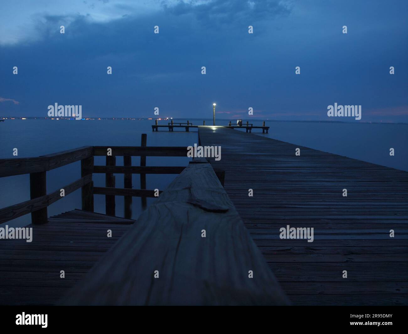 Dock at dusk with one street light at far end hi-res stock photography ...