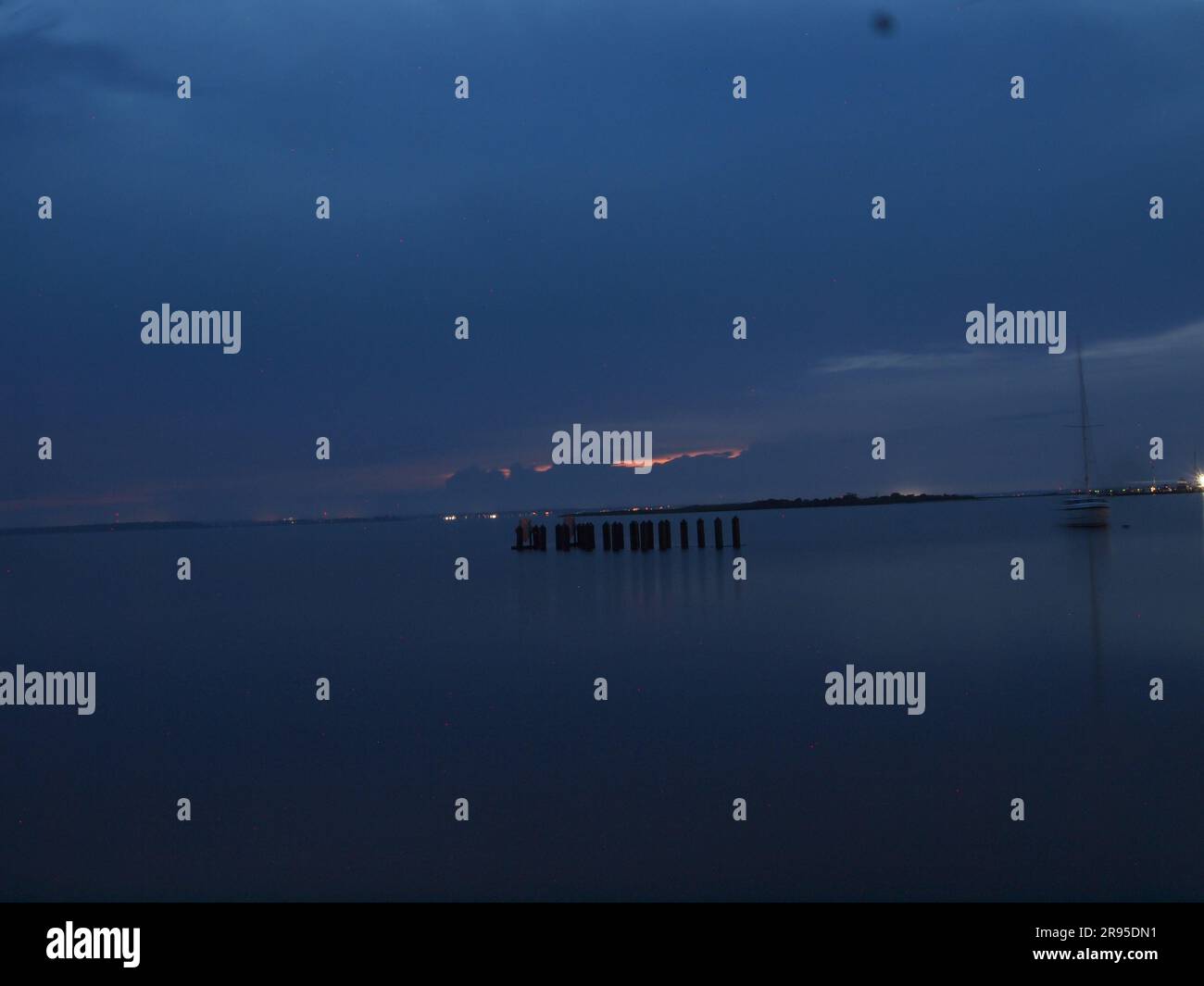 Dock at dusk with one street light at far end hi-res stock photography ...
