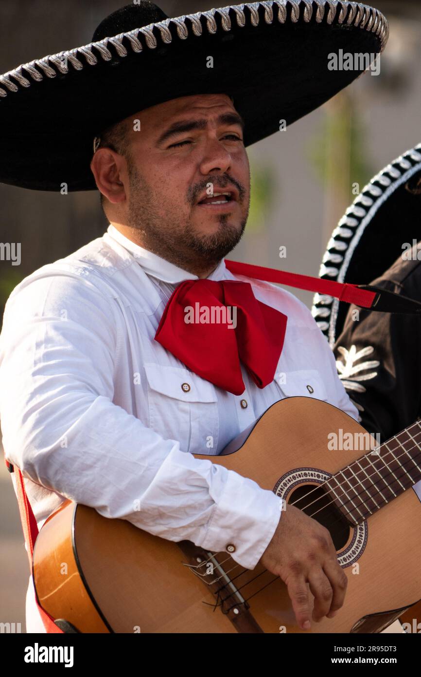 Mexican musician mariachi plays the guitar on a city street Stock Photo ...