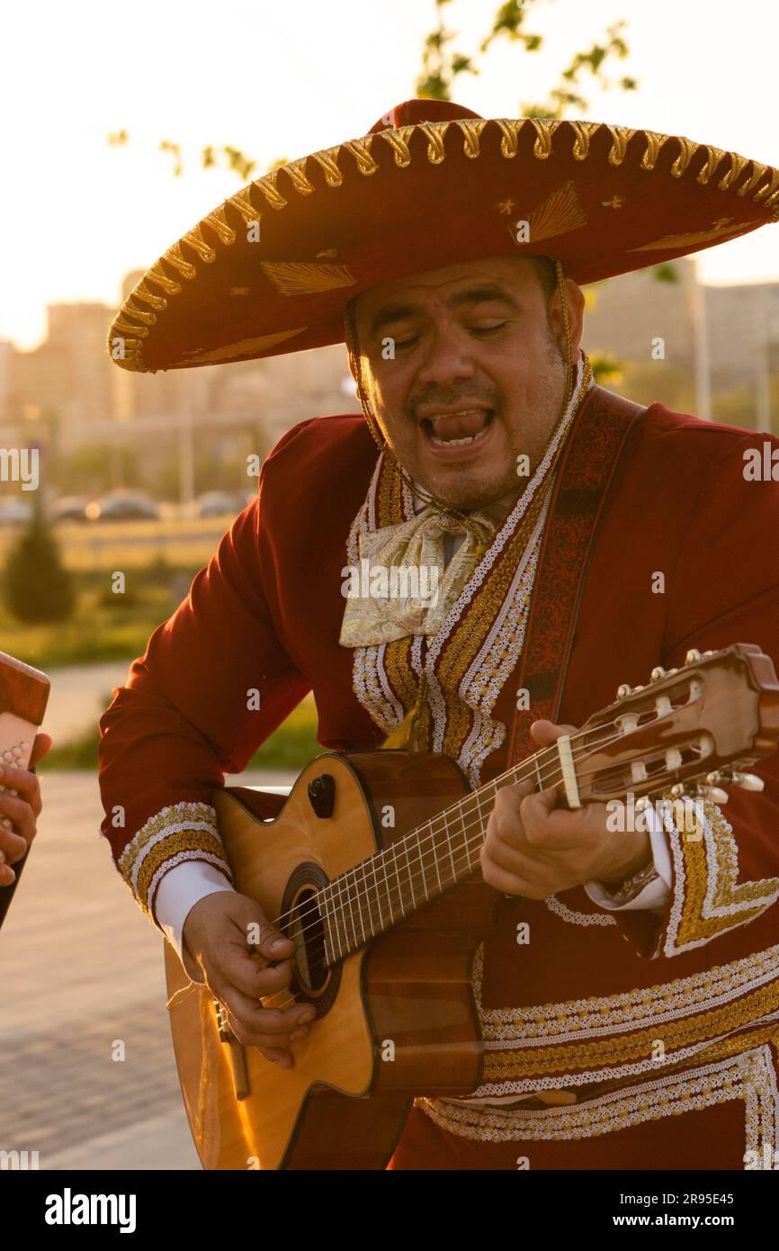 Mexican musician mariachi plays the guitar on a city street Stock Photo ...
