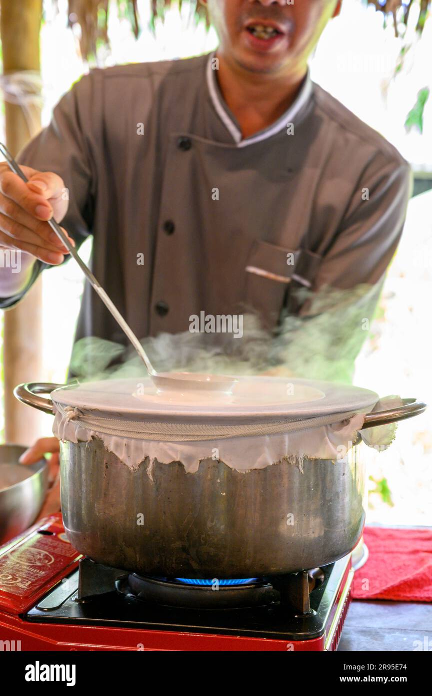 Chef and tutor demonstrates how to cook rice paper used for rolls and ...