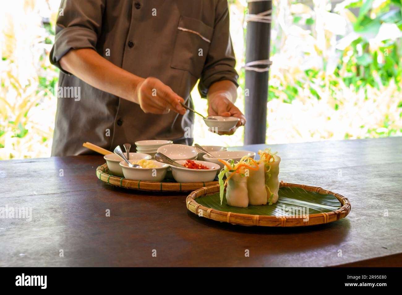 Chef and tutor with freshly made rice paper rolls with shrimp on a ...