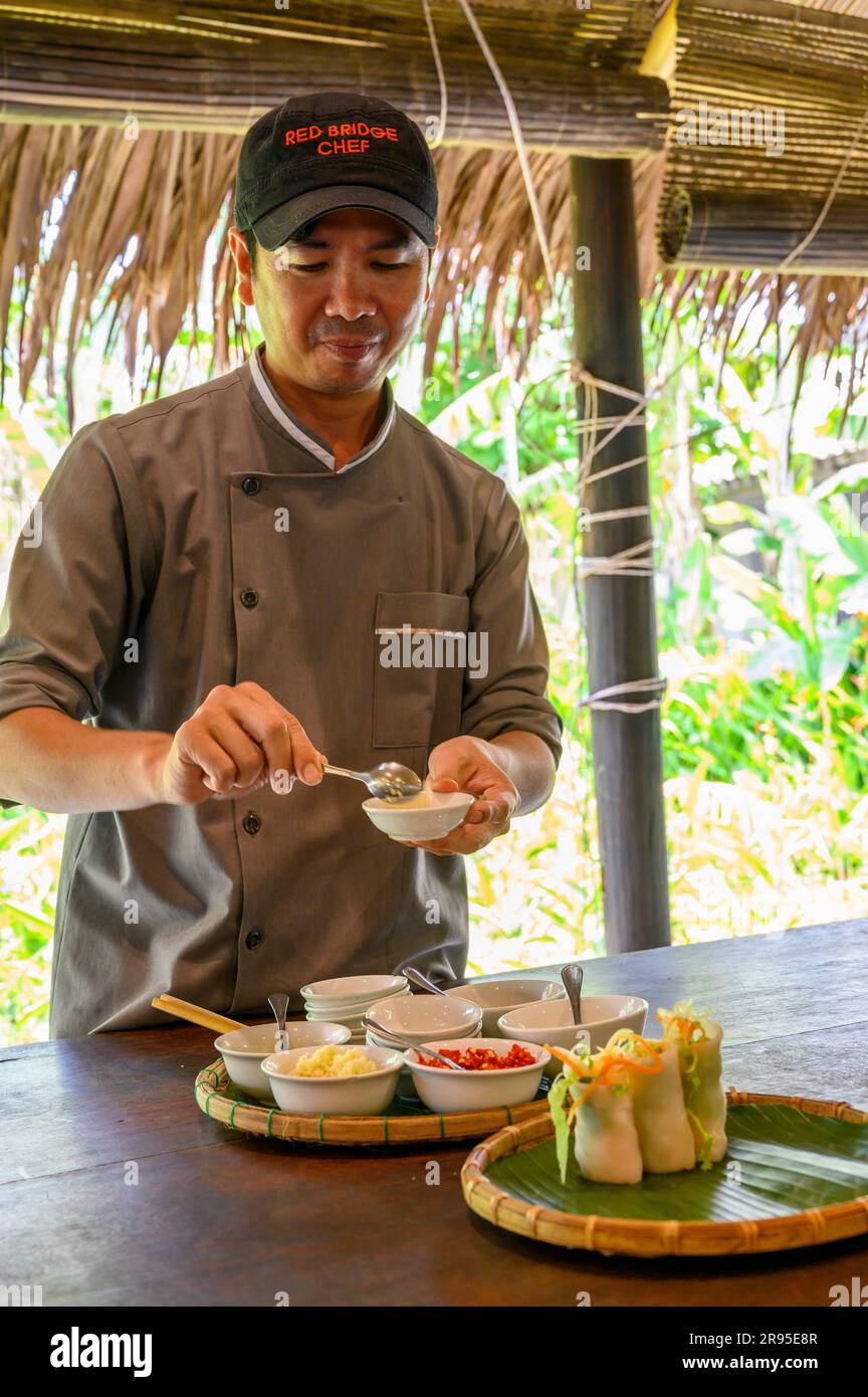 Chef and tutor with freshly made rice paper rolls with shrimp on a ...