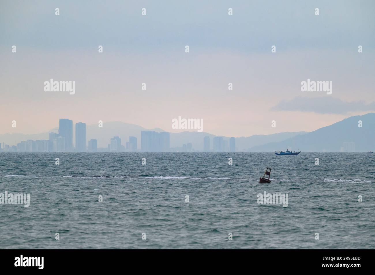View across the East Vietnam Sea bay to Da Nang skyline from the beach ...