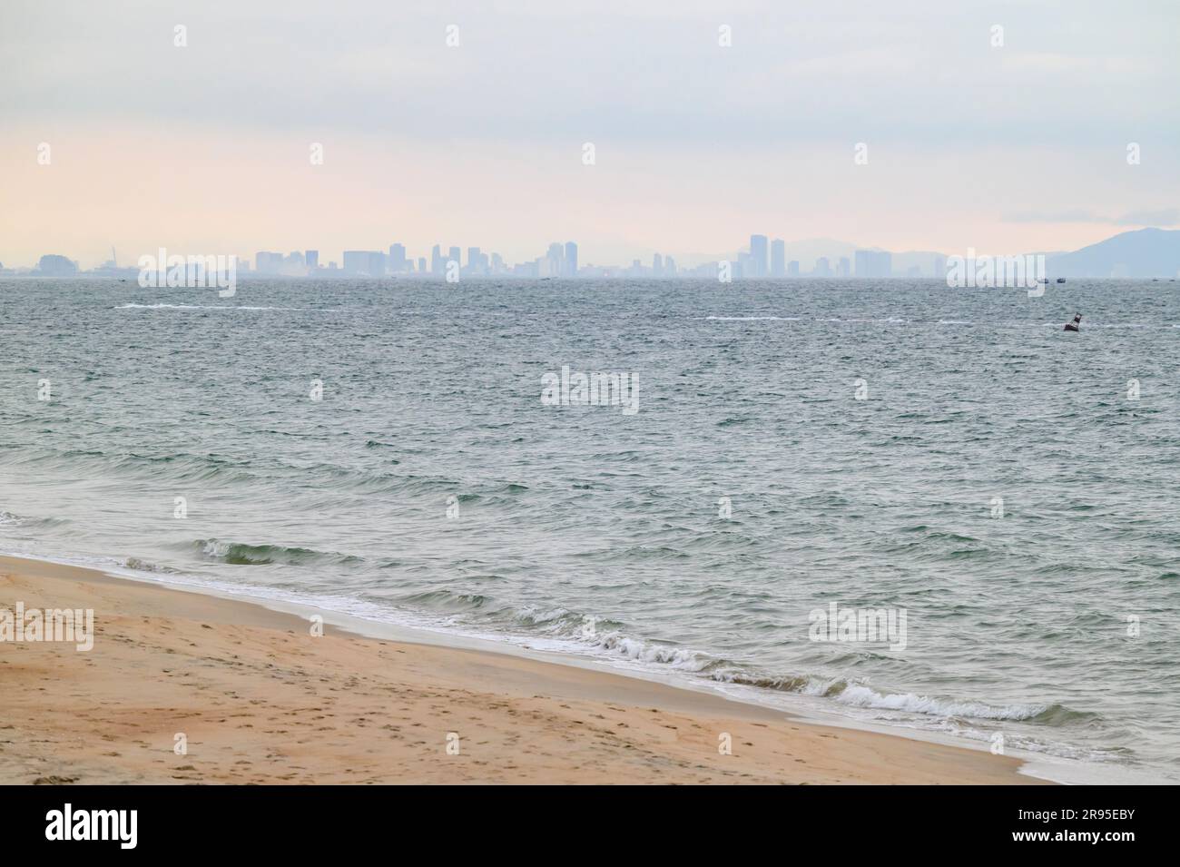 View across the East Vietnam Sea bay to Da Nang skyline from the beach ...