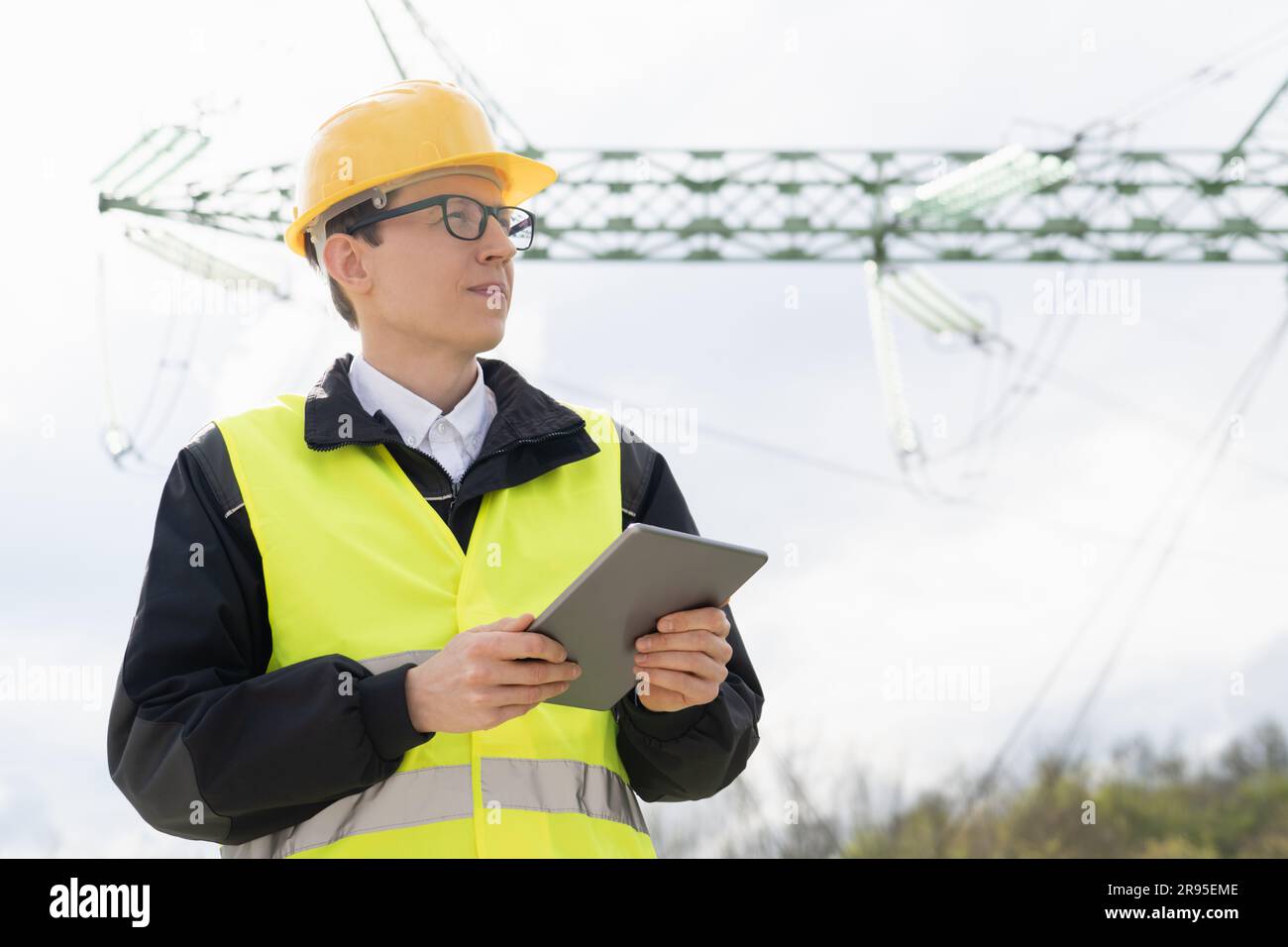 Engineer with digital tablet on a background of power line tower Stock ...