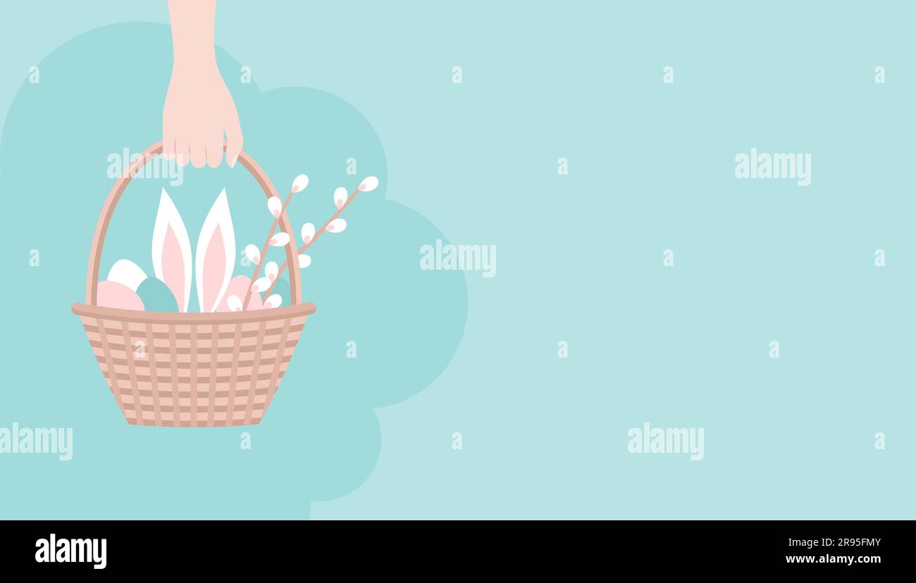 Hand holding Easter basket with eggs, rabbit ears and branches of willow blossom, copy space ...