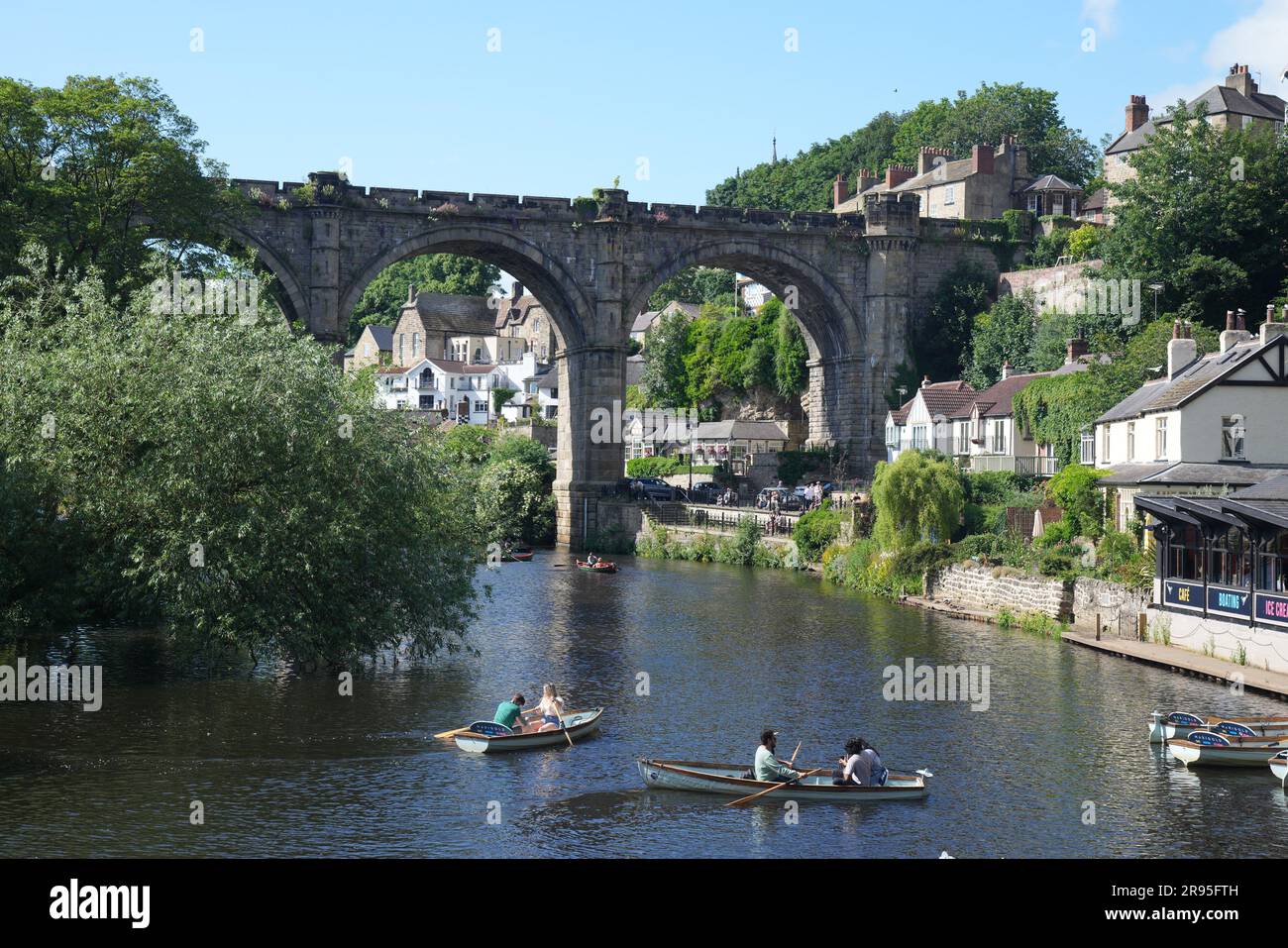 People enjoy the hot weather in rowing boats underneath the ...