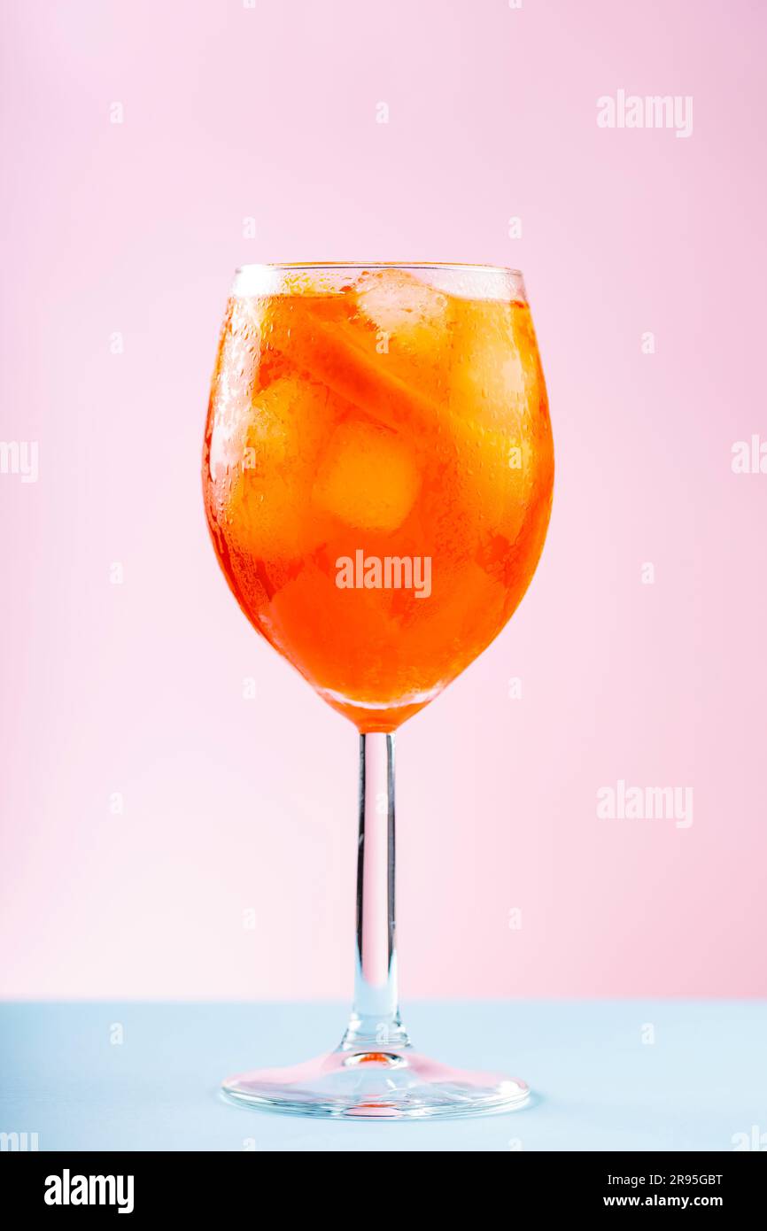 Aperol Spritz cocktail in glass on a pink blue background. Cocktail ...