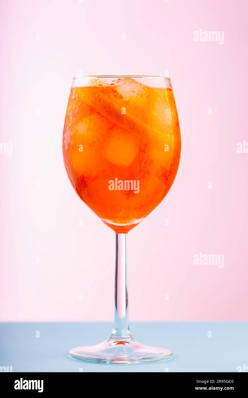 Aperol Spritz cocktail in glass on a pink blue background. Cocktail ...