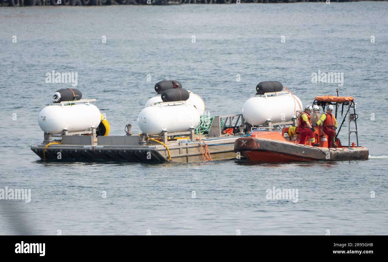 The Titan-sub launch barge is moved to the Coast Guard yard at port in ...