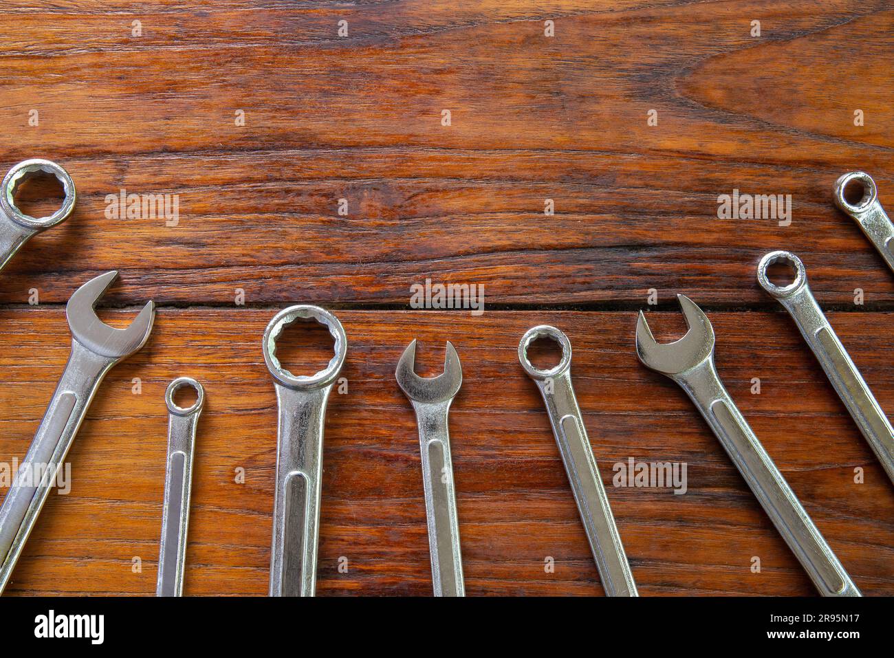 Metal bunch wrench tools lying on dark wooden background and top view ...