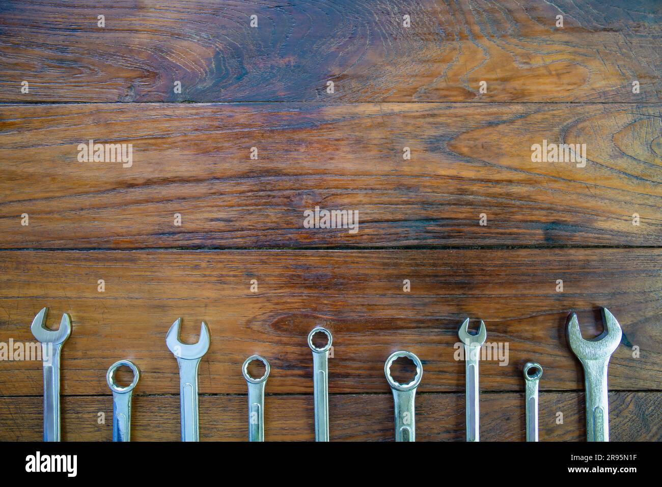 Metal bunch wrench tools lying on dark wooden background and top view ...