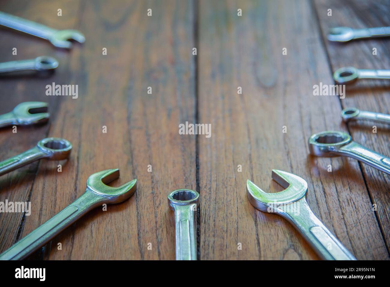 Metal bunch wrench tools lying on dark wooden background and top view ...