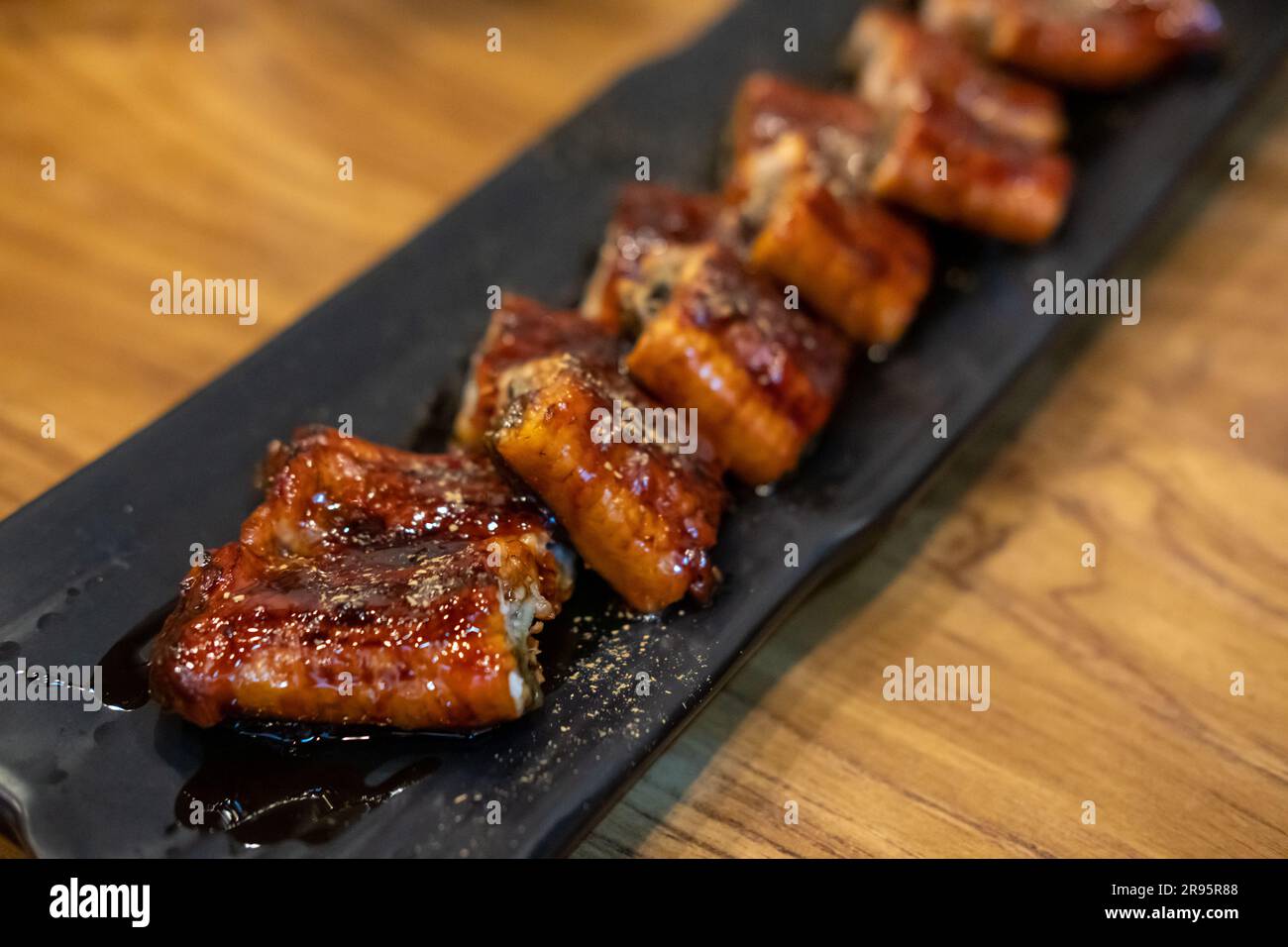 Sliced Unagi. Grilled eel with sauce served on plate Stock Photo - Alamy