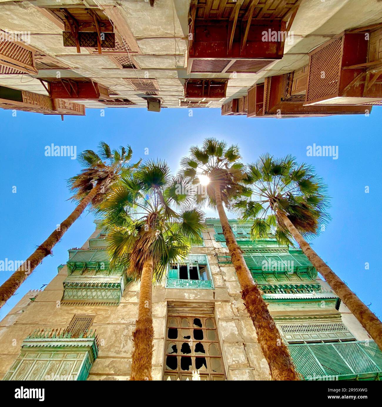A low-angle shot of an old building with palm trees in Jeddah, Saudi ...