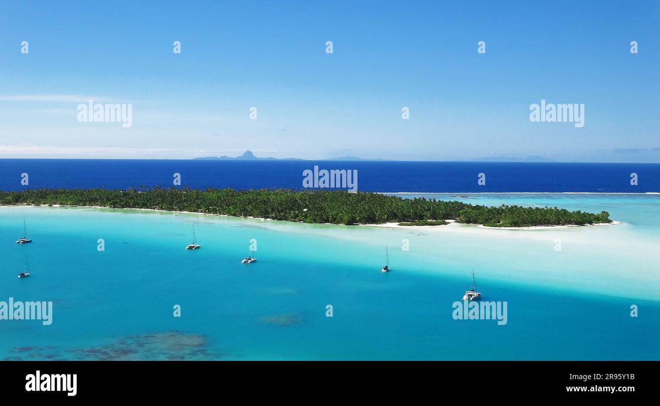 A scenic aerial view of a green island surrounded by blue waters and ...